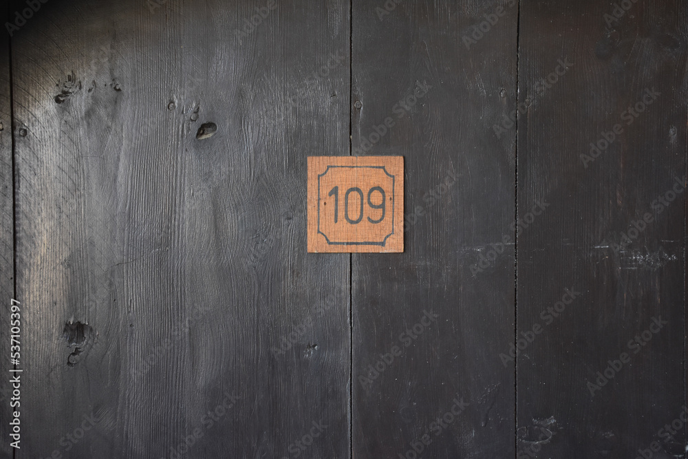 A mysterious wooden antique door with the number 109 on it. Can be used ...