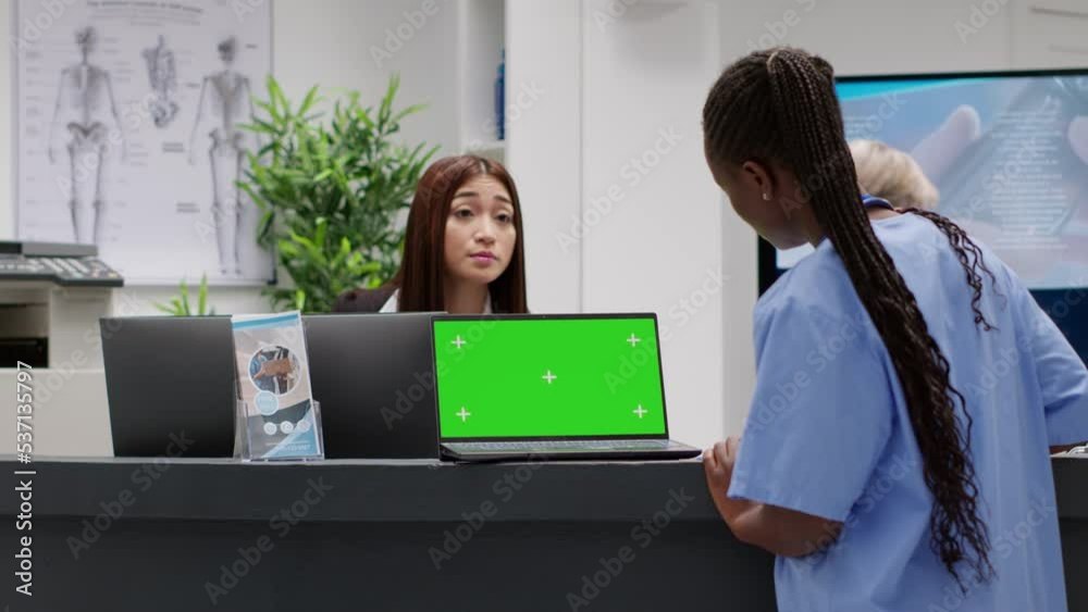Video Stock Nurse working at reception counter desk with greenscreen on ...