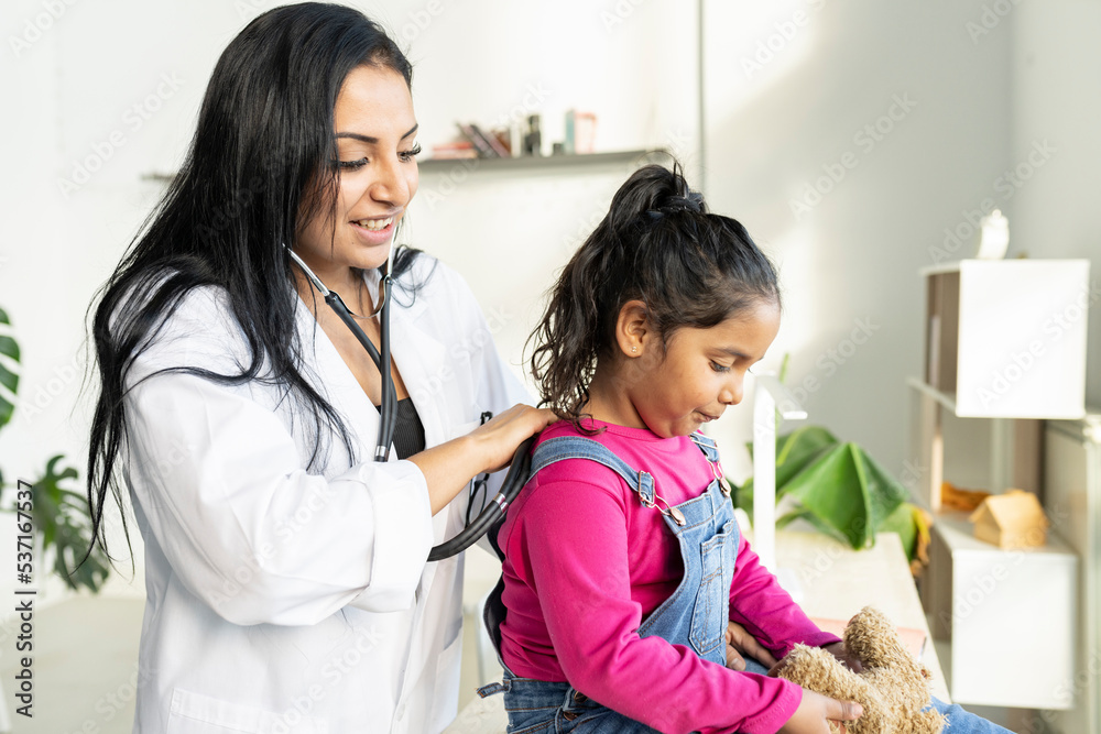 female doctor Hispanic pediatrician auscultating a small child - health ...