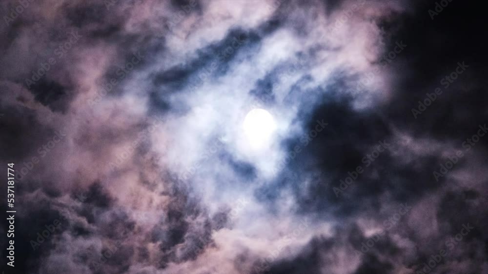 Full moon in the night sky moves through dark clouds, Timelapse. The ...
