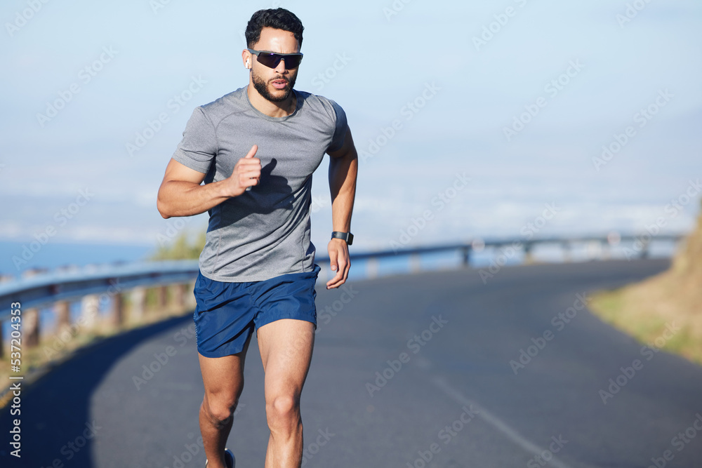Training, exercise and man running on road in city in summer with ocean ...