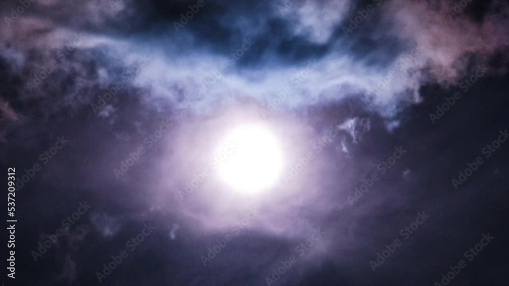Full moon in the night sky moves through dark clouds, Timelapse. The ...