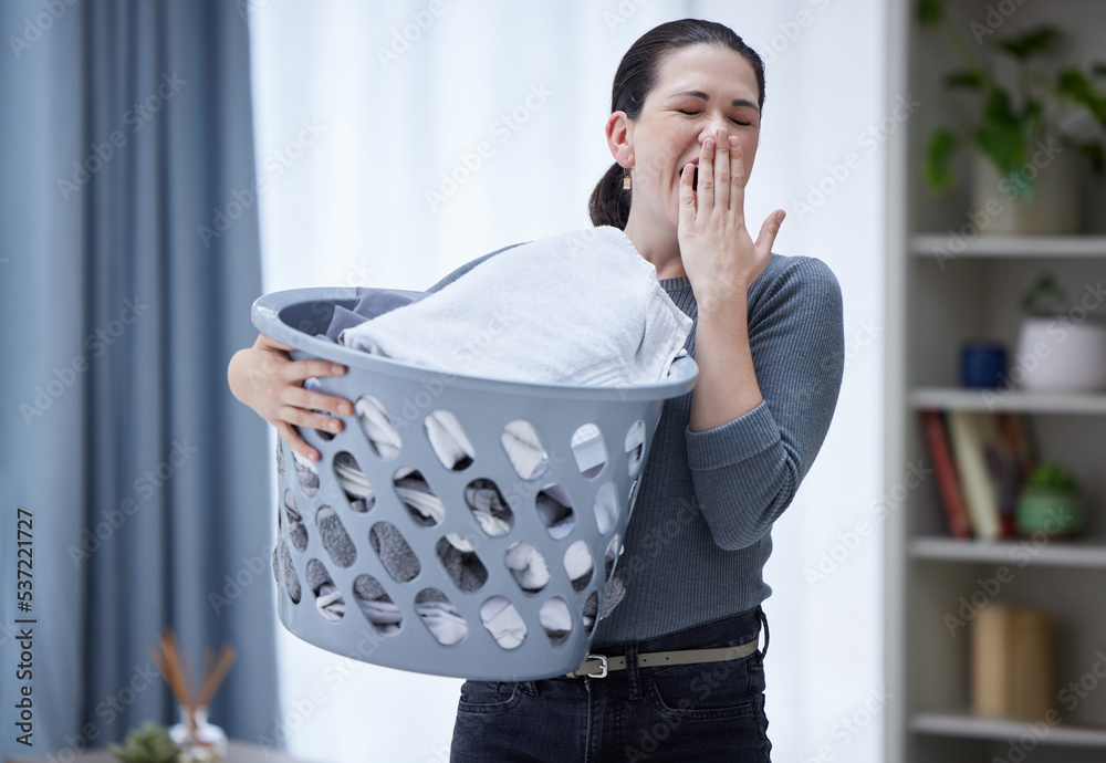 Tired, yawning and woman with laundry basket in home feeling stress ...