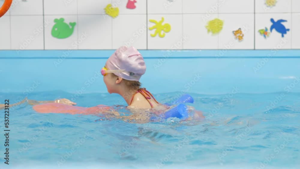 Individual swimming lesson with a personal trainer in an indoor pool ...