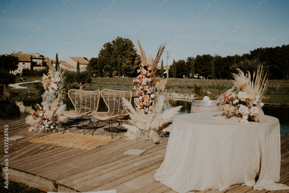 secular ceremony lay ceremony by the lake with nude and pink floral ...