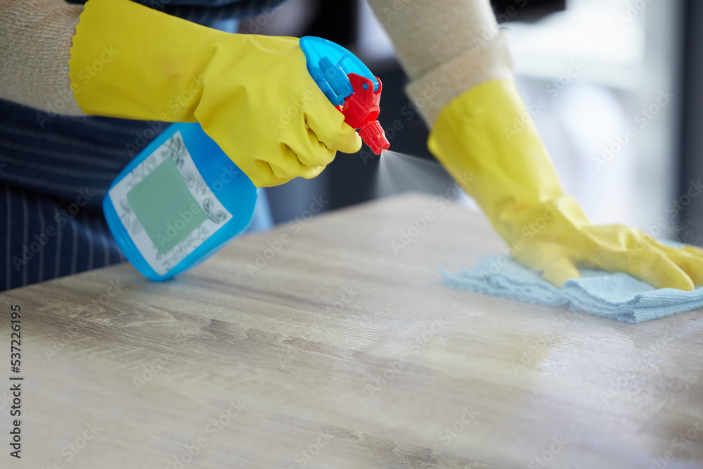 Hands, gloves and spray cleaning table with disinfectant for clean ...