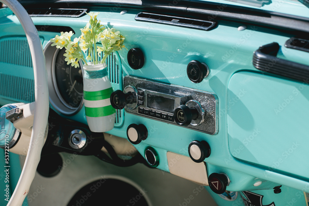 The interior of a vintage car is green. A close-up view of the radio ...
