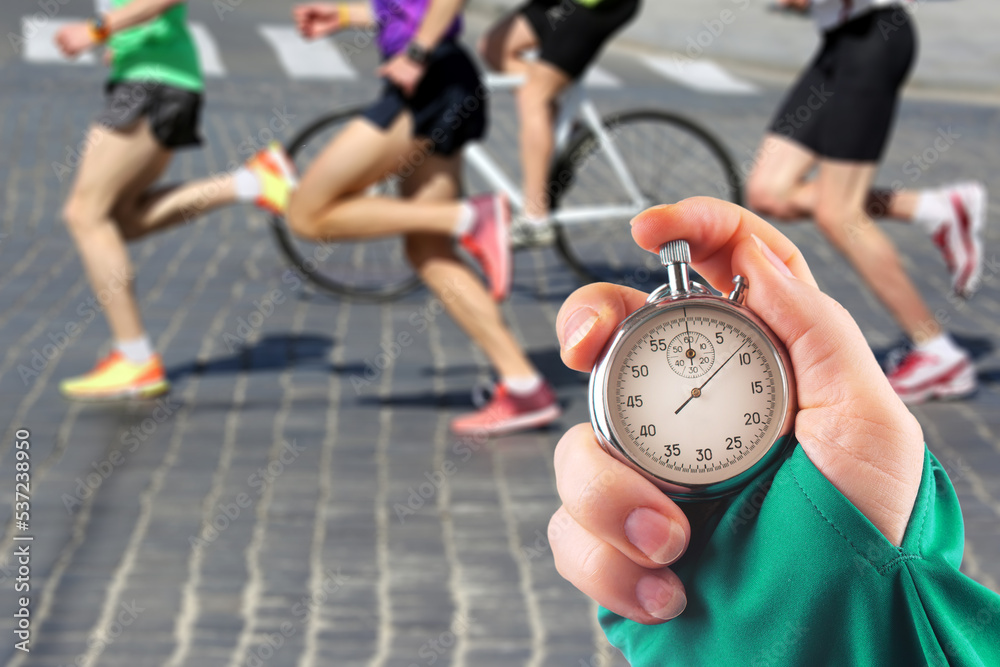 measuring the running speed of an athlete using a mechanical stopwatch ...