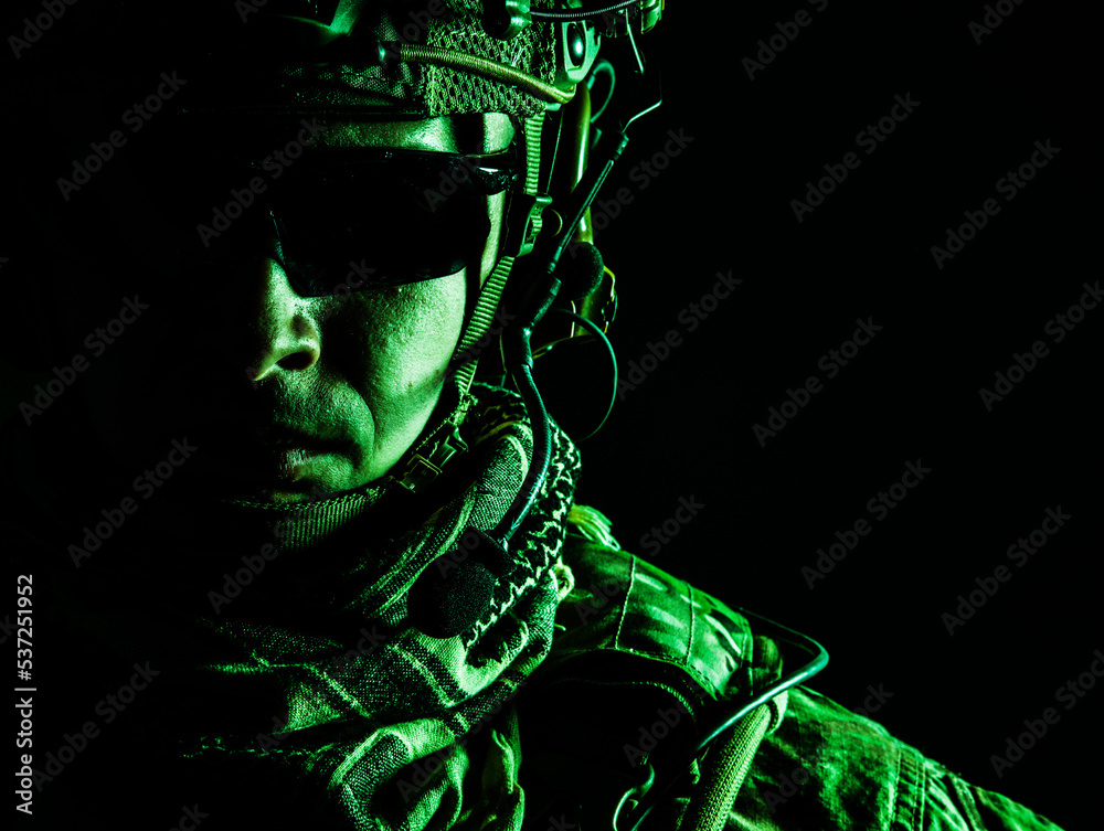 Elite member of US Army ranger in combat helmet and dark glasses ...