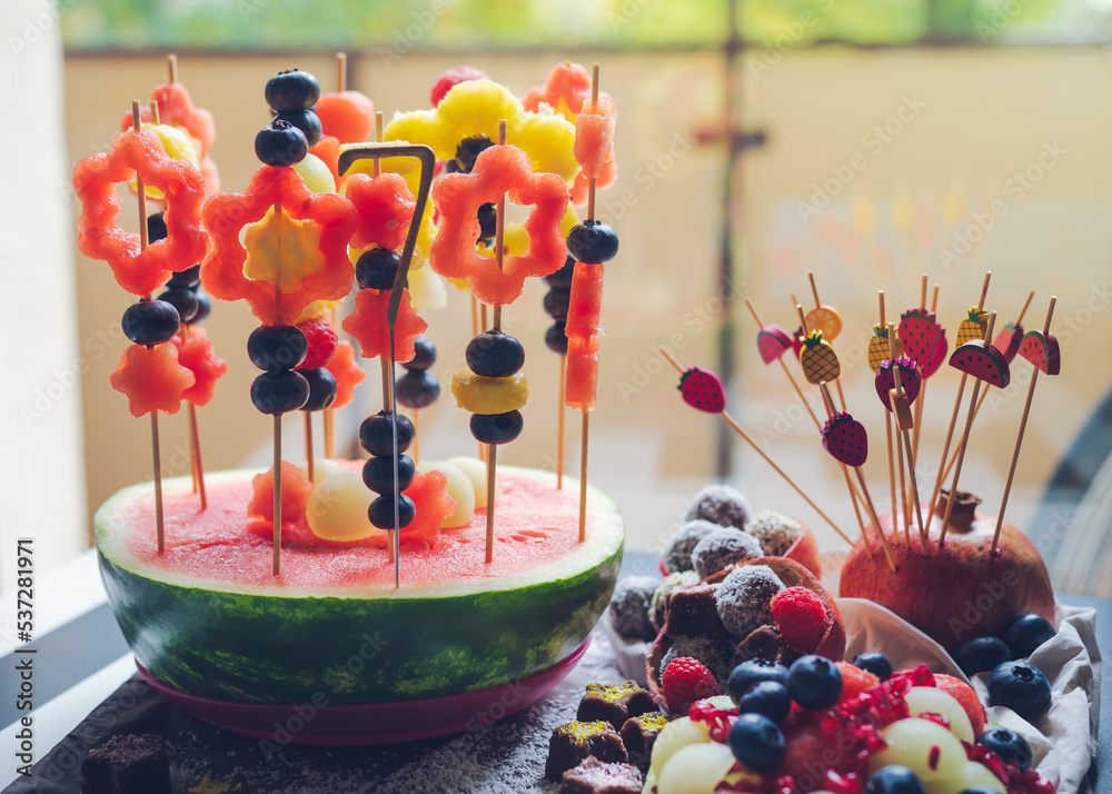 Colorful fruit dessert for a child's birthday. Various shapes of fruit ...