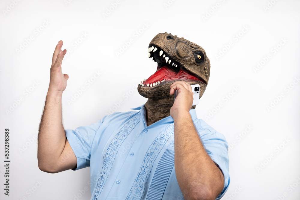 euphoric man with T Rex head talking on the phone. Absurd and surreal ...