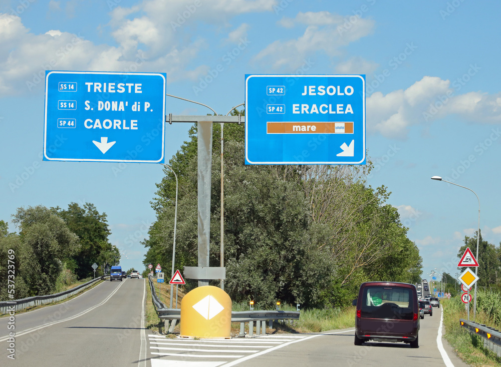 road signs at the crossroads with ITALIAN LOCALITIES written in on the ...