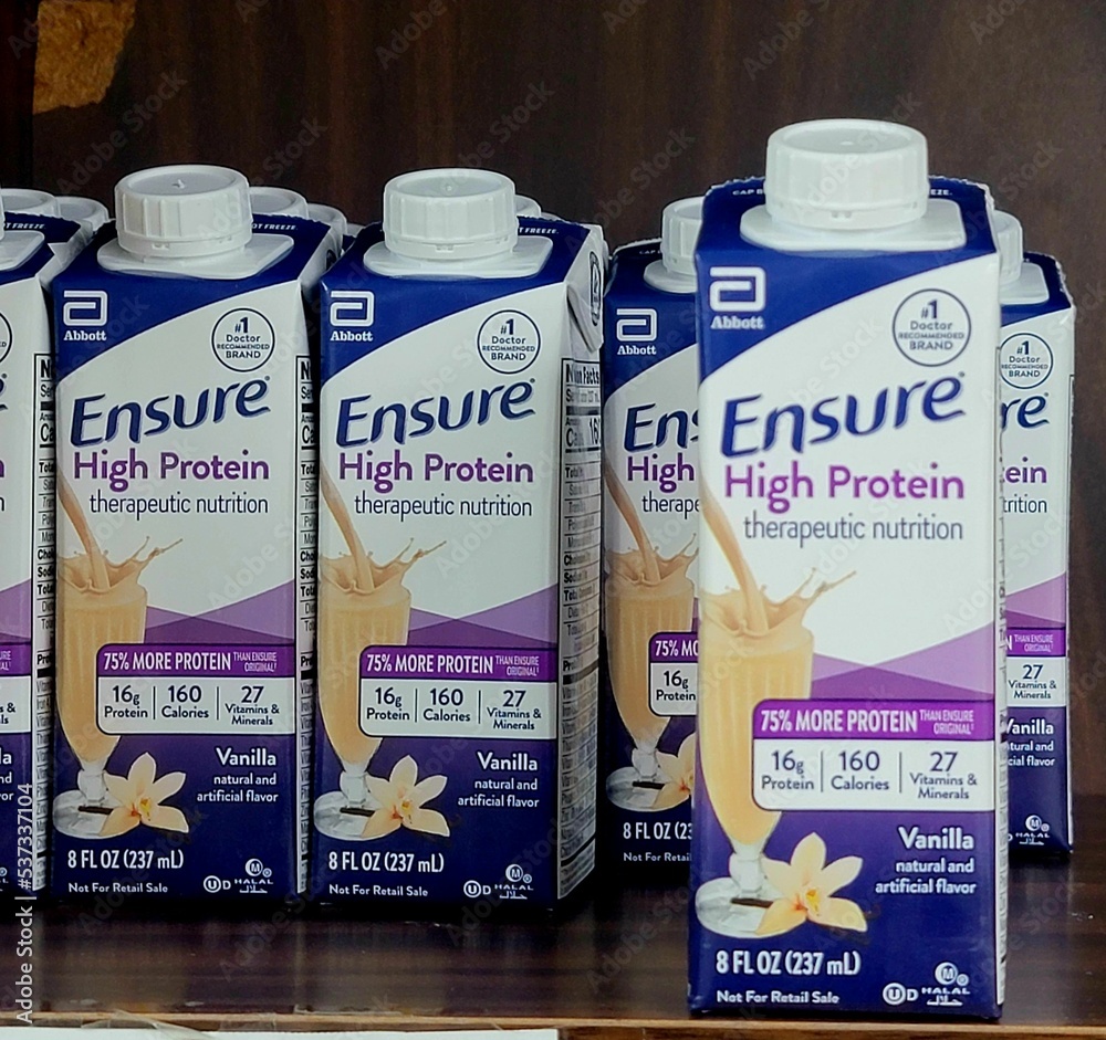 Row of plastic bottles of Ensure High Protein therapeutic nutrition ...