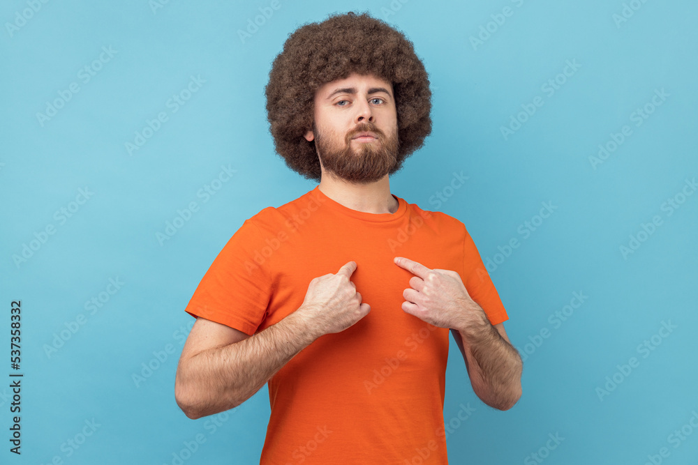 Portrait of man with Afro hairstyle drawing attention to itself ...