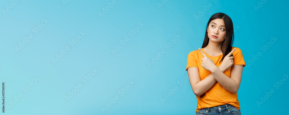 Confused cute asian female student thinking what do, look sideways ...