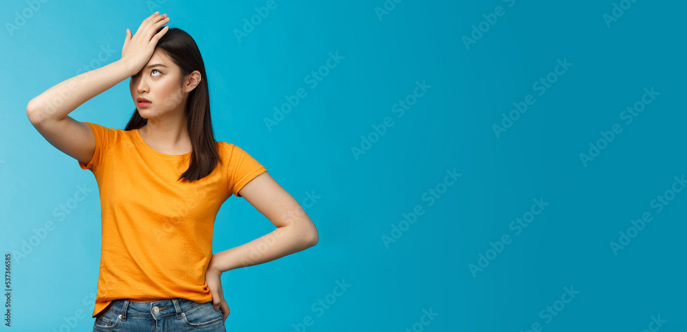 Annoyed arrogant asian girl punch forehead make facepalm sign, roll ...