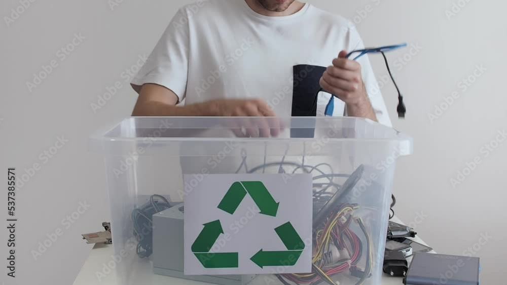 Hazardous E-Waste Recycling. Man throws broken household electrical and ...