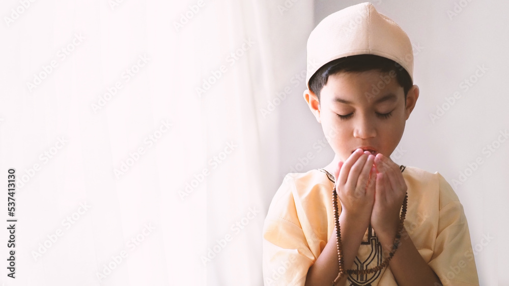 Muslim pre school kid pray to God (Doing Dua or supplication).Concept ...