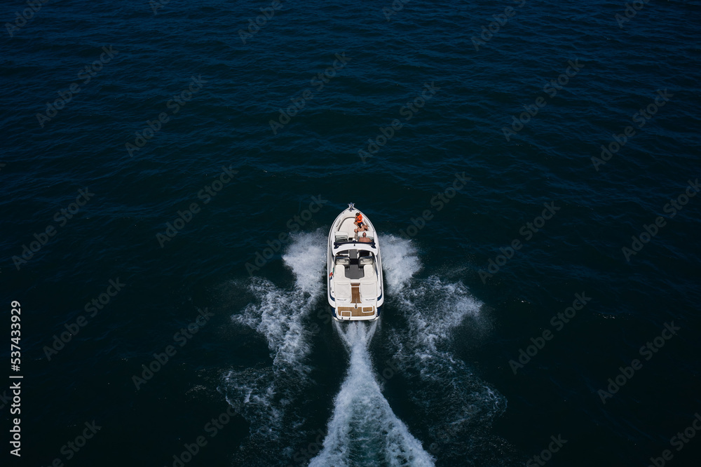 Big white motor boat movement on the water back view. Top view of the ...