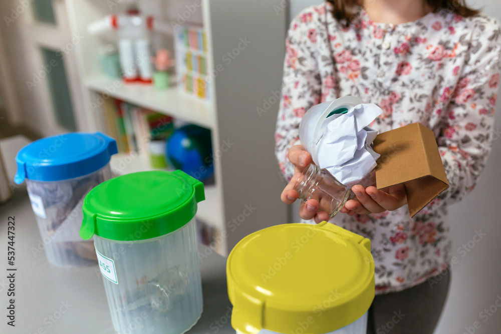 Unrecognizable girl in ecology classroom showing handful of waste to ...