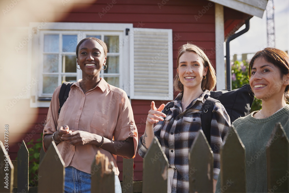 Smiling friends standing together Stock Photo | Adobe Stock
