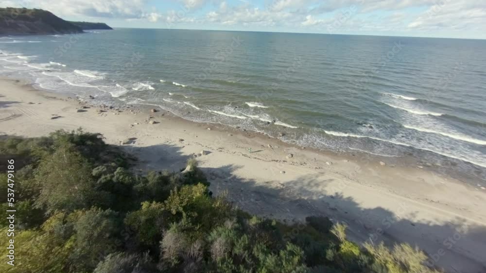 Green hill over sandy shoreline Stock Video | Adobe Stock