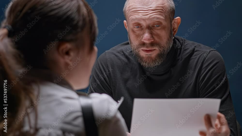 Female detective shows to suspected criminal photo of evidence from ...