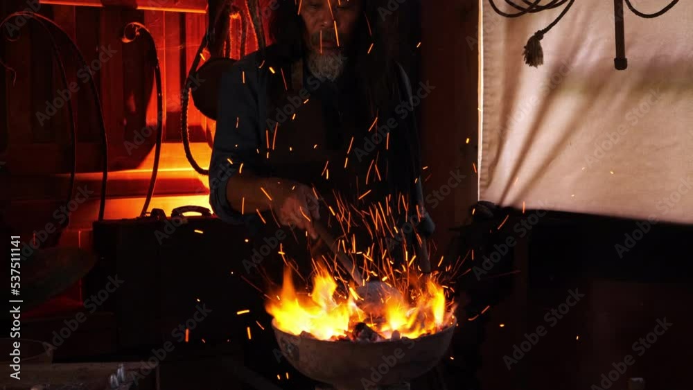 Close-up, Blacksmith cowboy man work, the horseshoe is worked on anvil ...