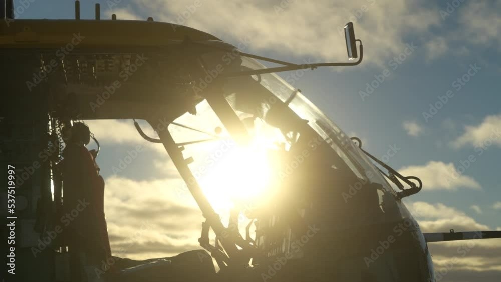 Helicopter cabin in sun. Side view. Door to cabin opened. Cockpit and ...