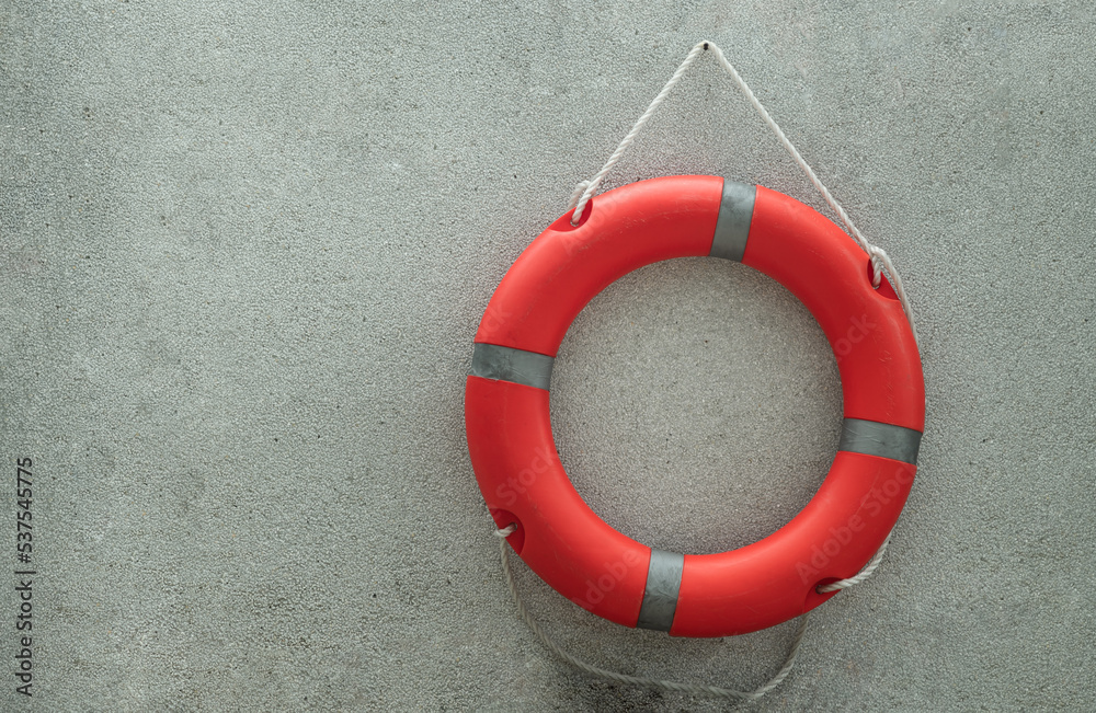 Orange lifebuoy with grey strips (Rescue ring buoy) .hanging on small ...