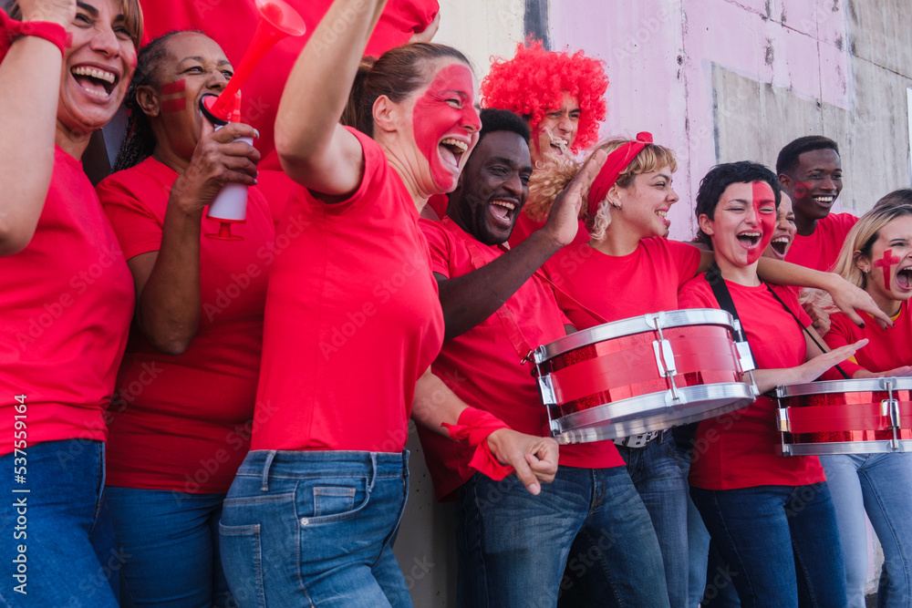 Local fans of the national team defending their colors and singing and ...