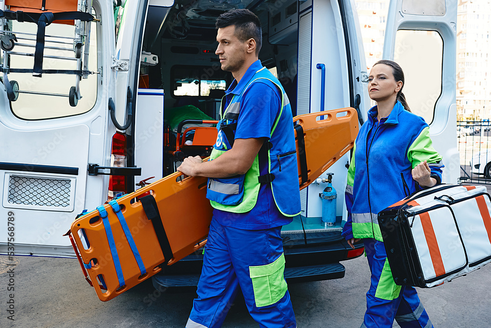 Emergency medical services. Paramedics with first aid medical equipment ...