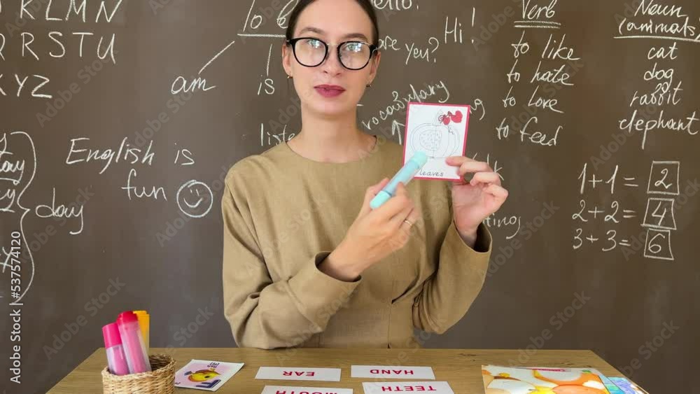 Stockvideo Learning English remotely. young teacher conducts online lesson using flashcards to ...