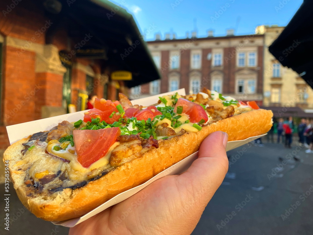 Delicious long polish Zapiekanka baguette outdoor. Traditional Polish ...