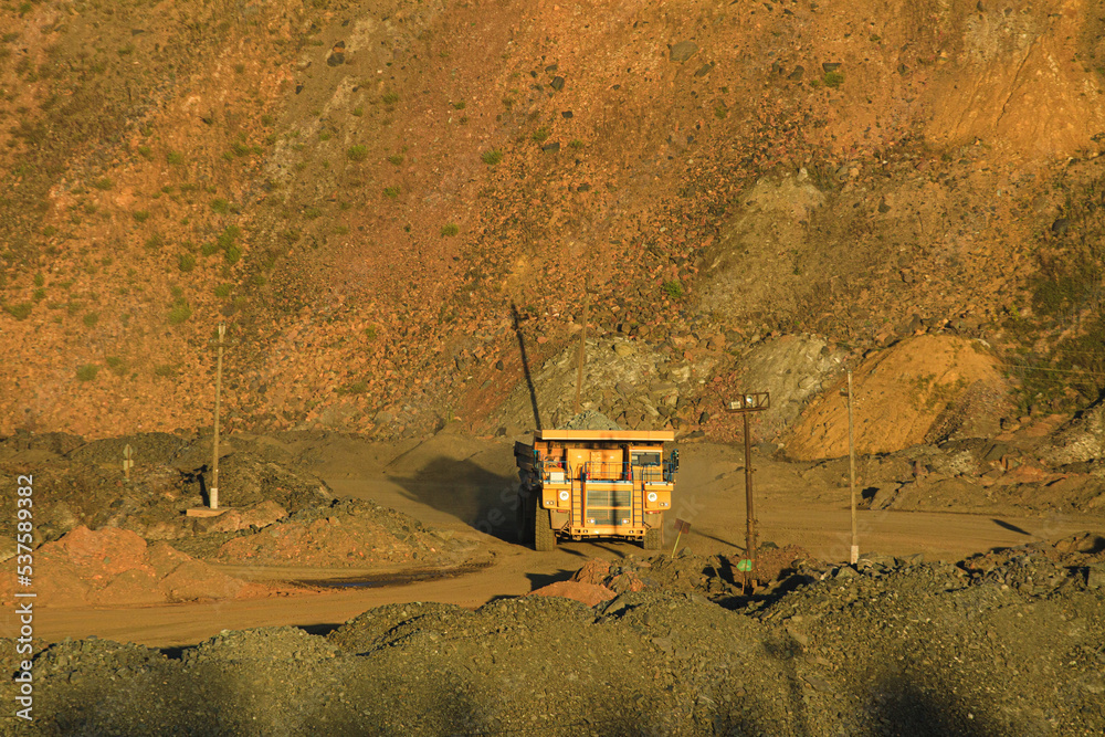 Large yellow quarry dump truck for transporting rock mass in the quarry ...