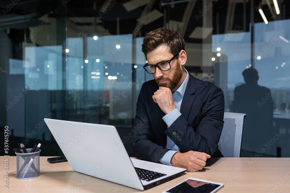 Serious thinking businessman working inside office building, man ...