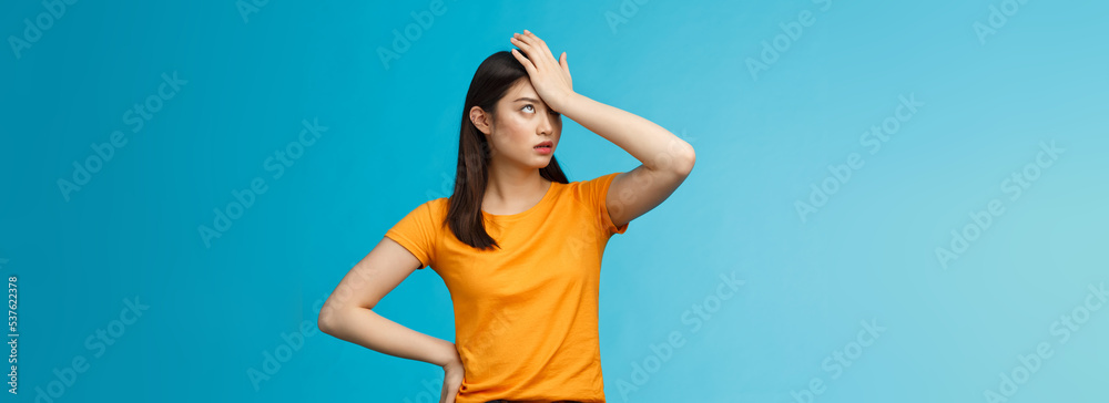 Annoyed arrogant asian girl punch forehead make facepalm sign, roll ...