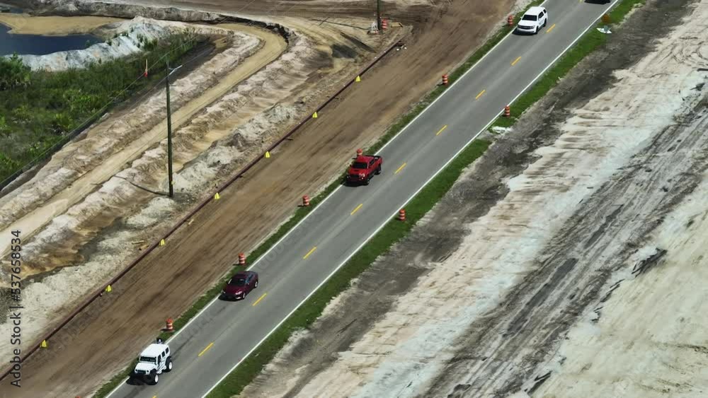 Aerial view of american highway under construction with moving traffic ...