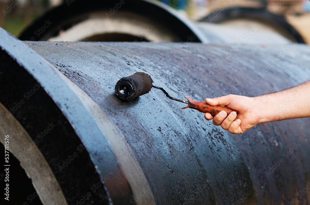 Construction roller in the man's hand. The process of painting ...