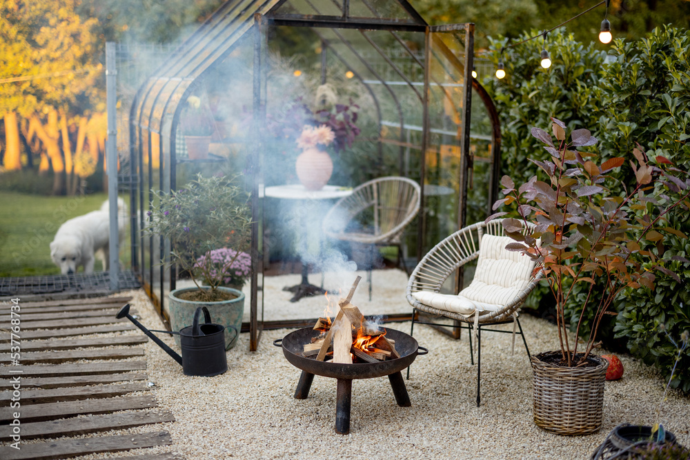 Beautiful and cozy garden with a picnic fire at lounge area and vintage ...