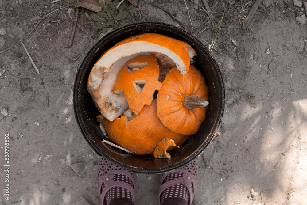 Composting concept. Rotten, spoiled pumpkin monster in the trash ...
