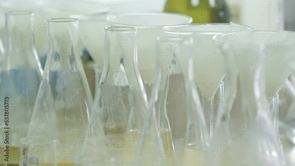 Multiple glass flasks filled with egg yolk liquid at the test ...