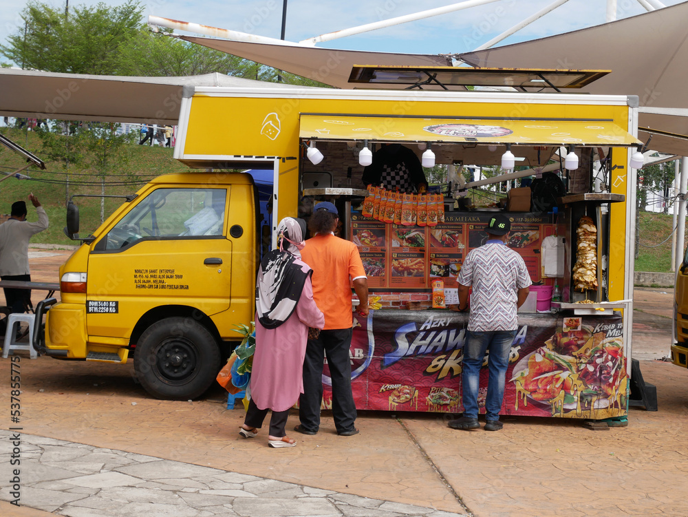 MELAKA, MALAYSIA - APRIL 6, 2022: Food vendors use food trucks to sell ...