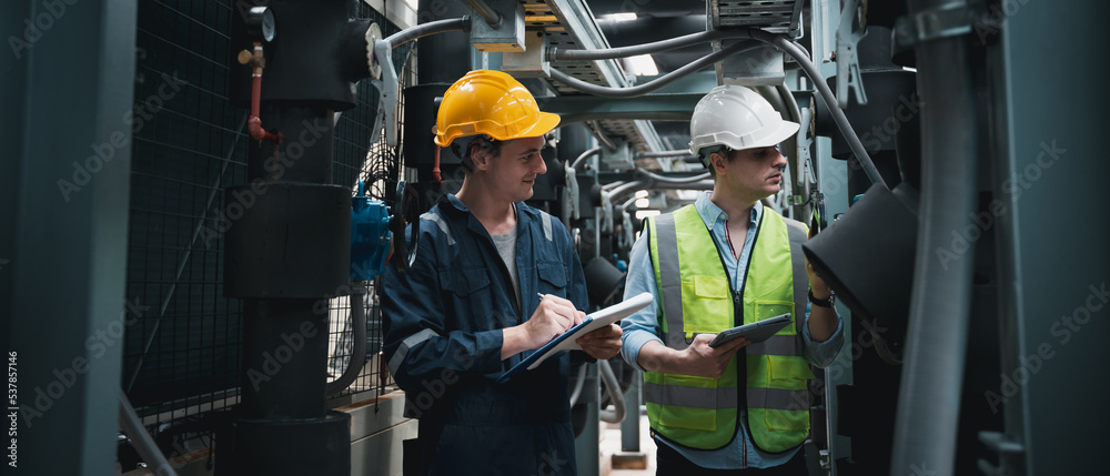 Engineer and team examining the air conditioning cooling system of a ...