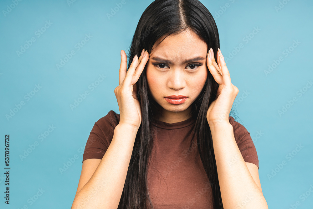 Asian beautiful women feeling confused and headache isolated over blue ...