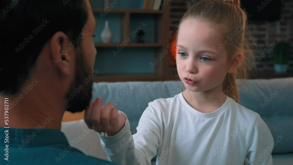 Affectionate little girl kid playing with daddy touching parent face stroking soft male beard ...