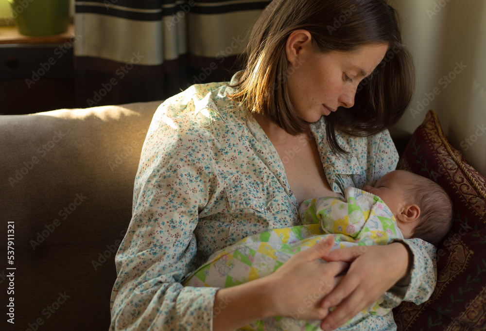 beautiful woman breastfeeding her baby Stock Photo | Adobe Stock