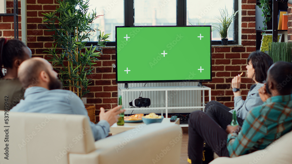 Diverse people watching movie on television with greenscreen template ...