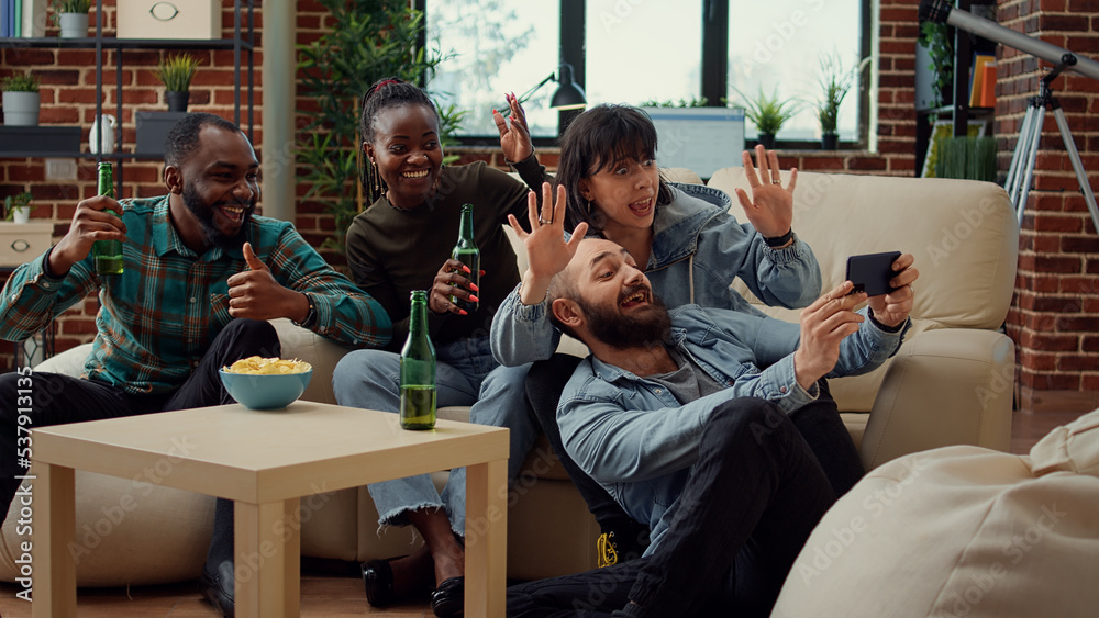 Cheerful people having fun with photos on smartphone, taking pictures ...