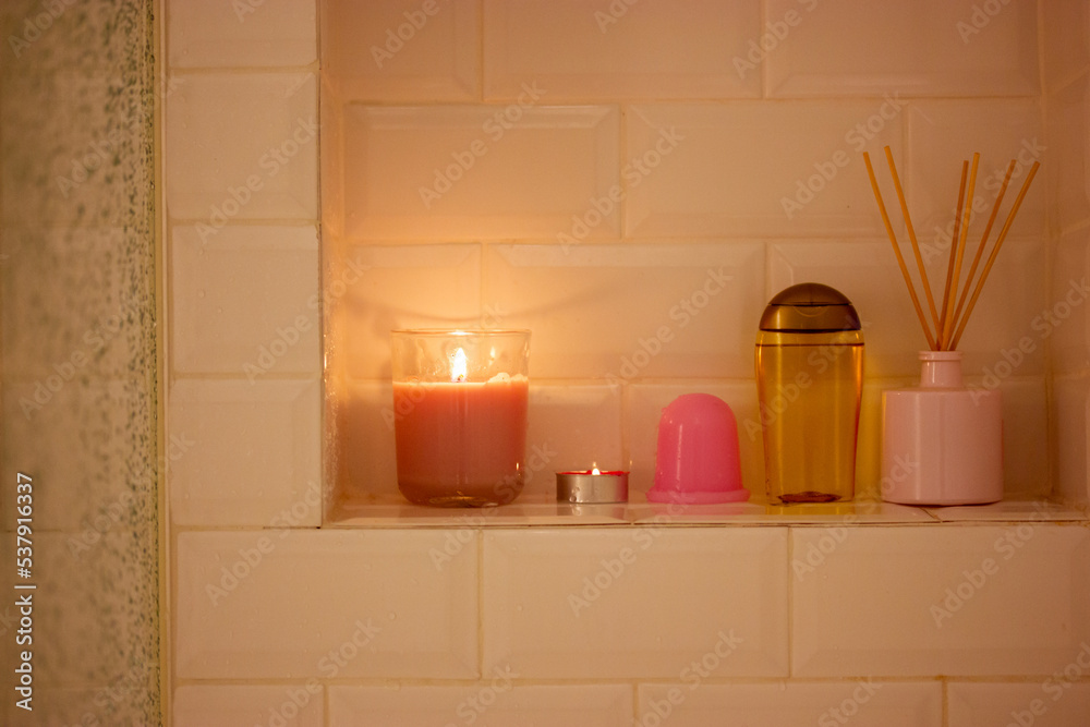 Shower cubicle with water drops on glass. Containers of cosmetics for ...